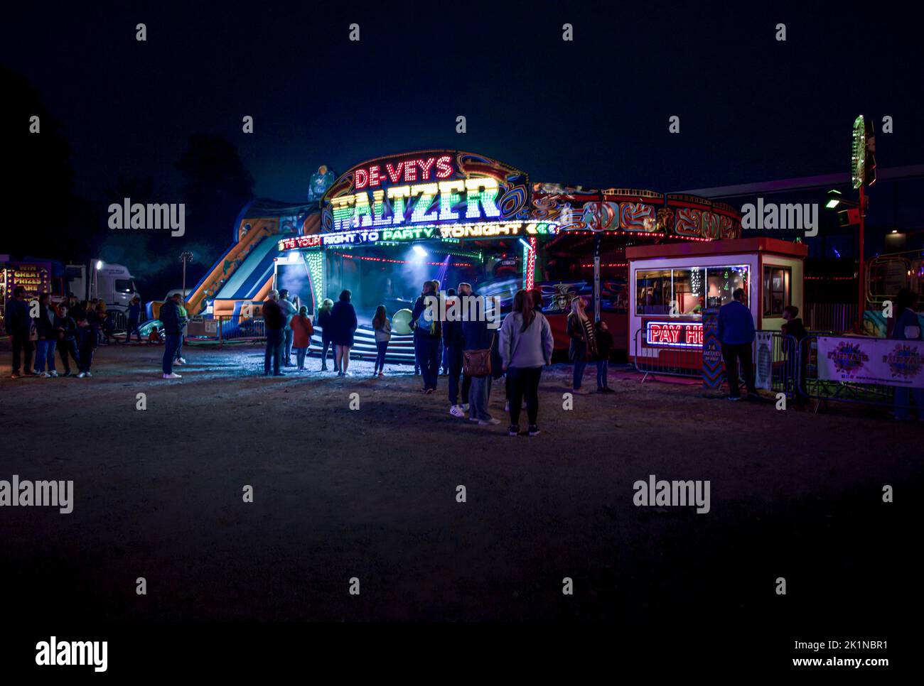 Spinning rides, waltzer at funfair in summer at night Stock Photo - Alamy