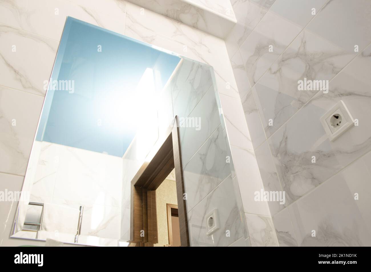 Reflection of the bathroom in the mirror and stretch blue ceiling, wall ...