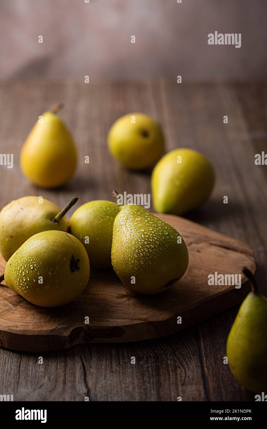 Fresh pears on a wooden board with water drops on the peel Stock Photo ...