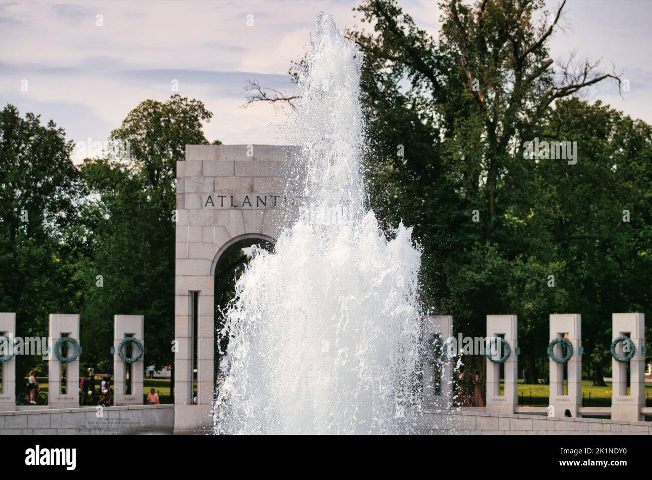 Water shoots upwards from a fountain at the center of the World War II ...