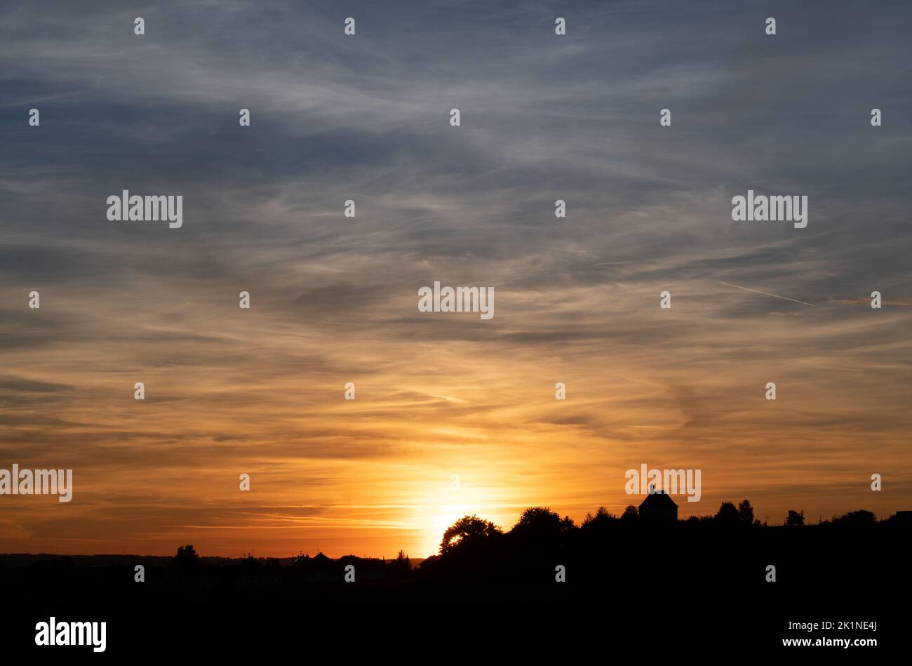 Dramatic sunset in Bavaria. The sky is full of clouds. The colors ...