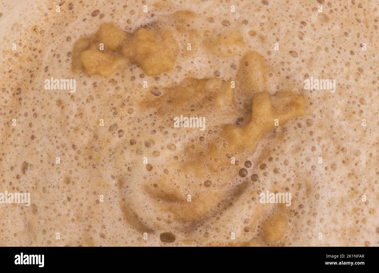 An the process of cooking apple jam. The jam boils and the foam appears ...