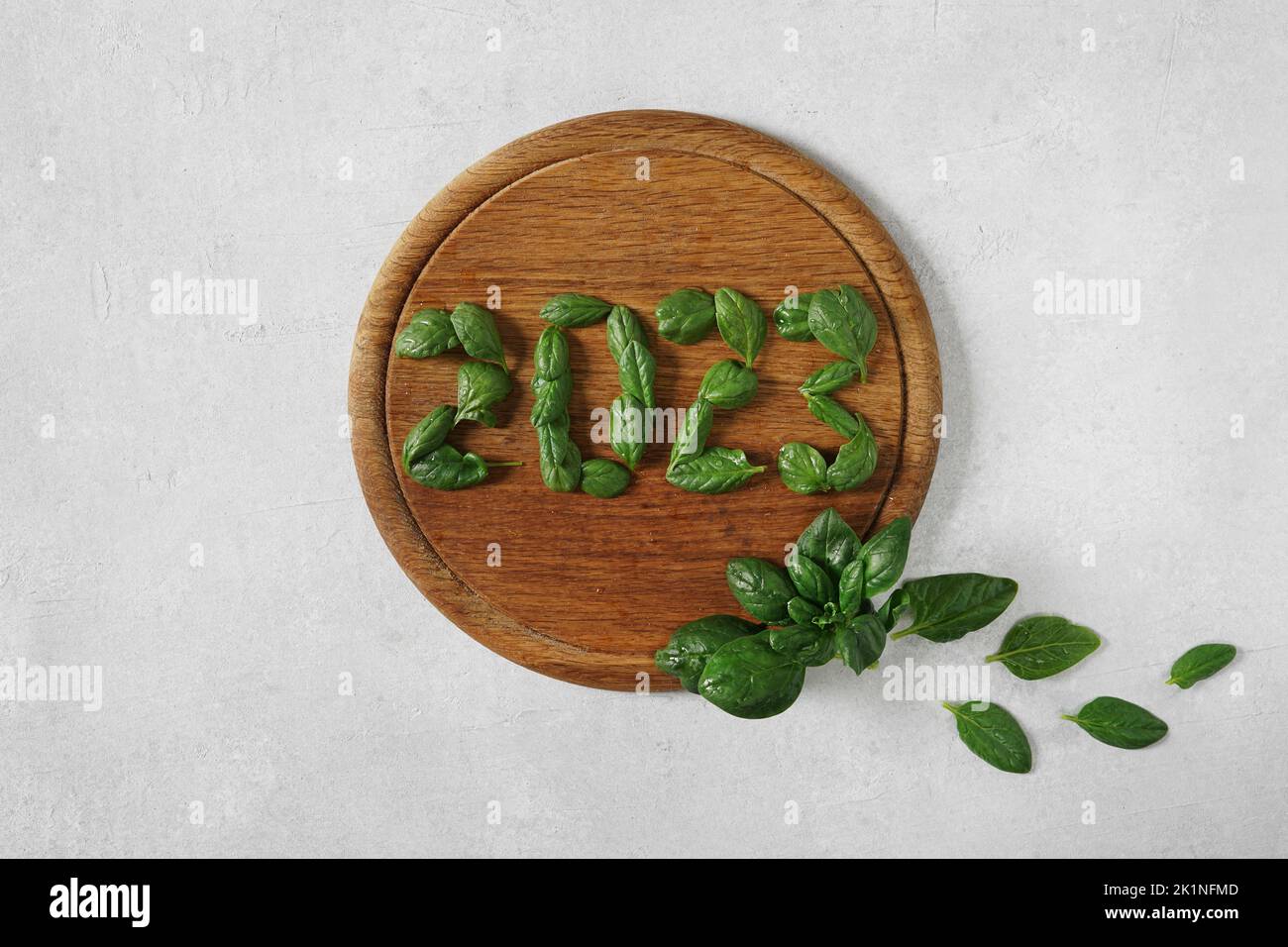 2023 made of spinach leaf on a wooden cutting board, health and healthy ...