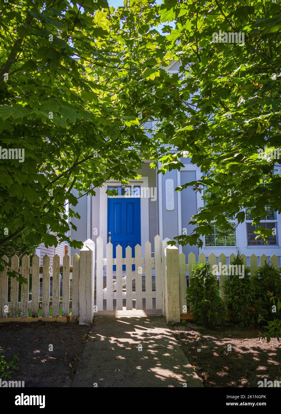 Entrance to a home through a beautiful garden with colorful flowers ...