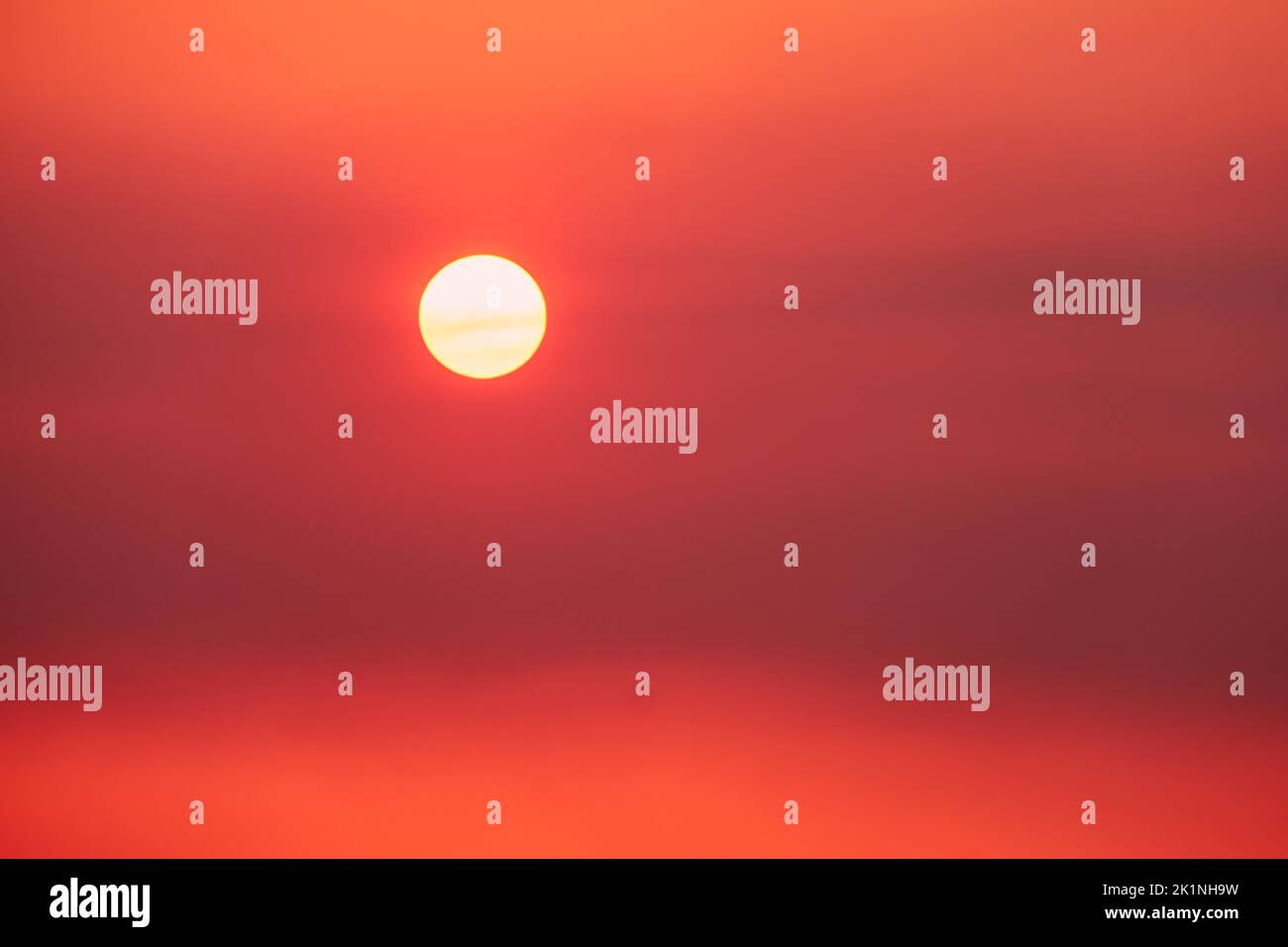 A big red sun in the sunset sky, a summer landscape. Evening sky in hot ...