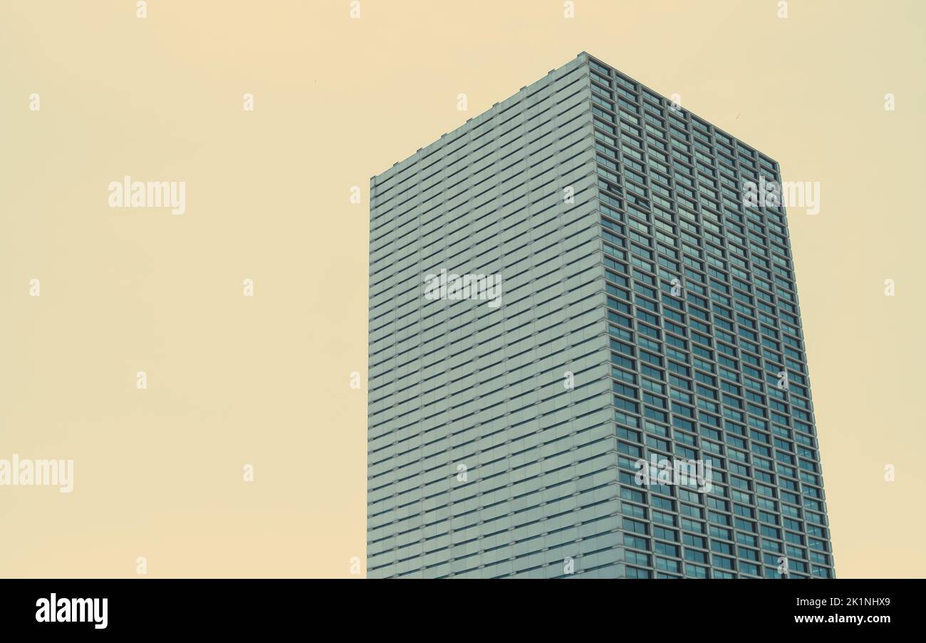 View of a teal facade and corner of a tall contemporary business office ...