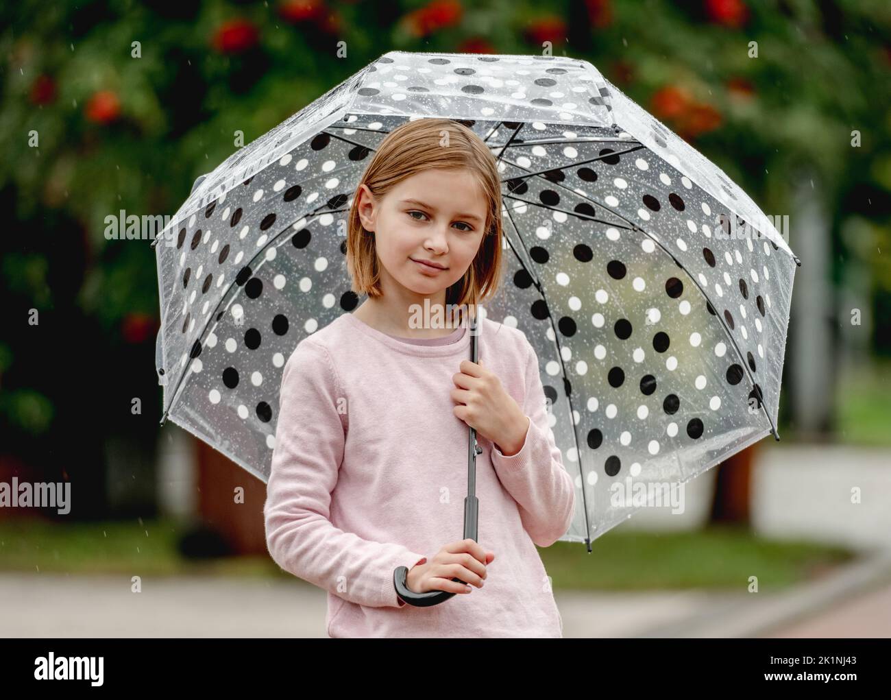 Preteen girl with umbrella Stock Photo - Alamy