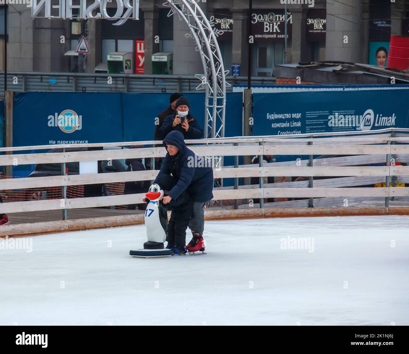 Dnipro, Ukraine - 02.10.2022: People have fun skating on a public ice ...