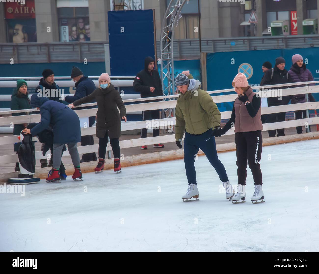 Dnipro, Ukraine - 02.10.2022: People have fun skating on a public ice ...