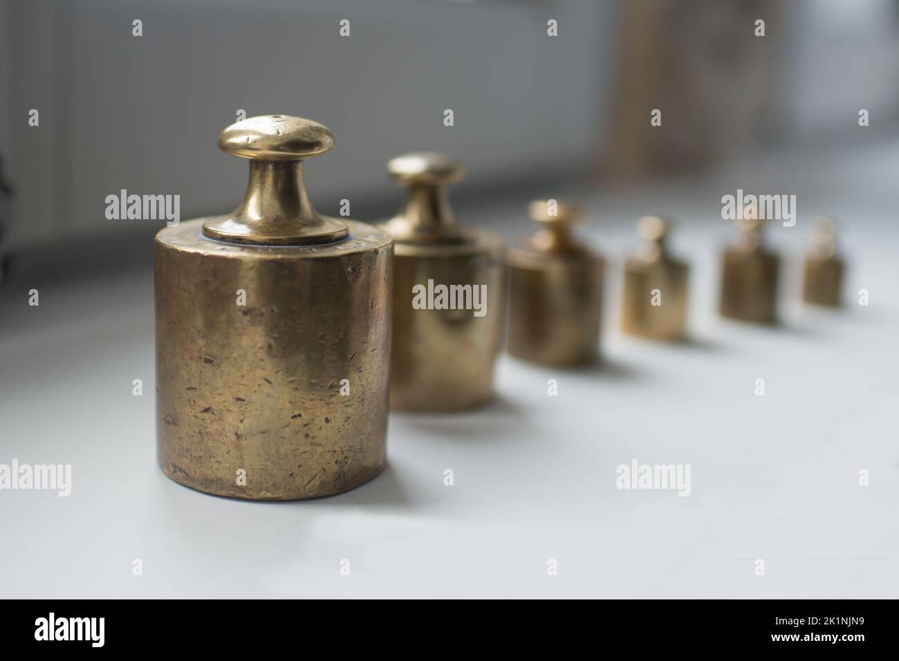 Antique set of metal weights in a row. The biggest the nearest Stock ...