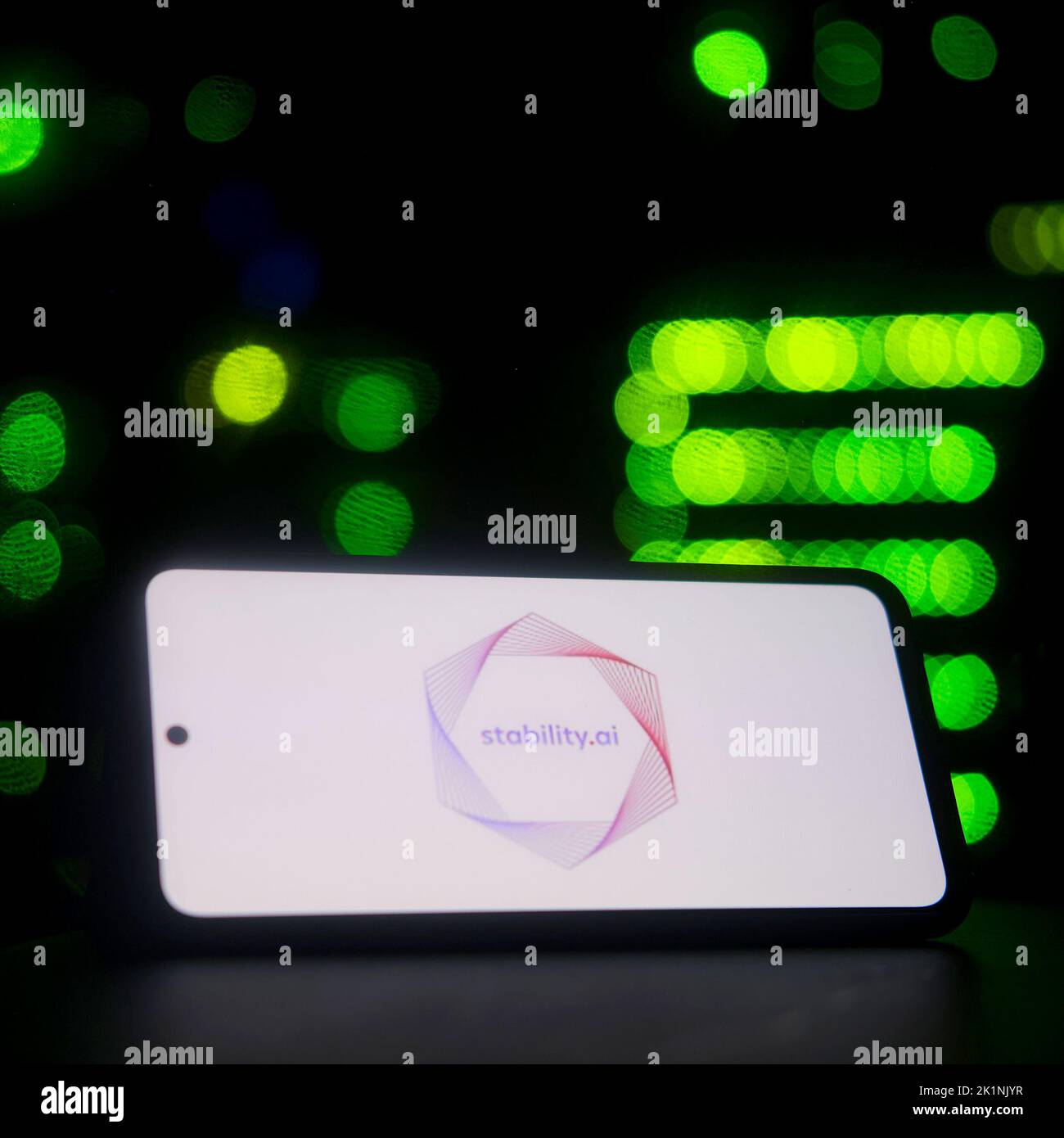 Logo stability ai on the phone screen on the background of the server room. Smartphone with ...