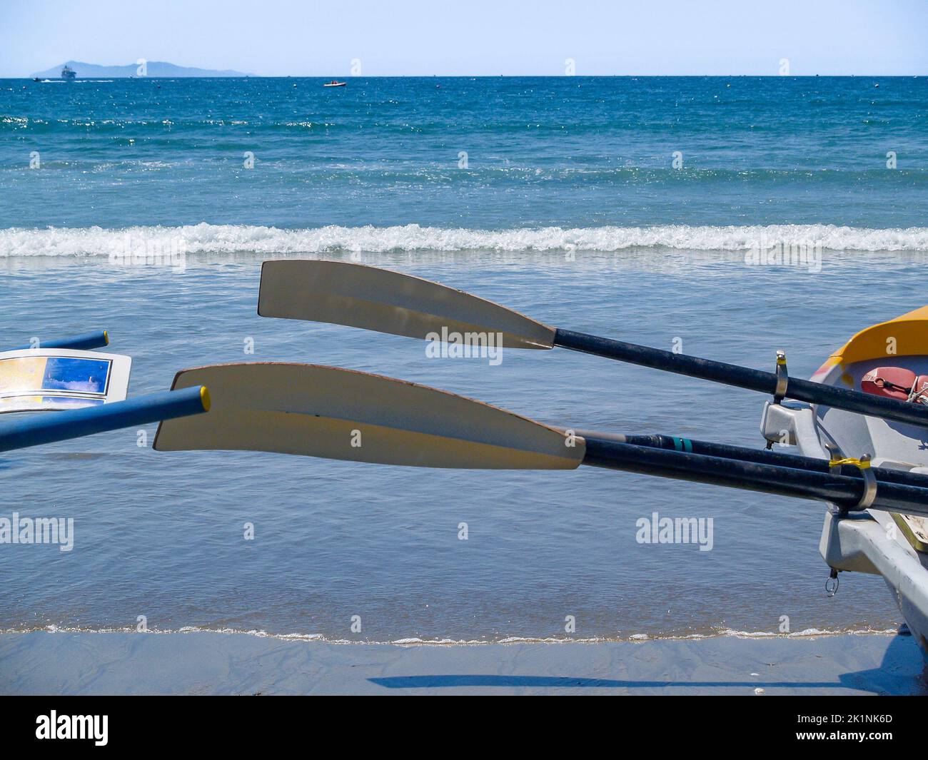 Oars of two surf-boats pulled up at water line with view across ocean ...