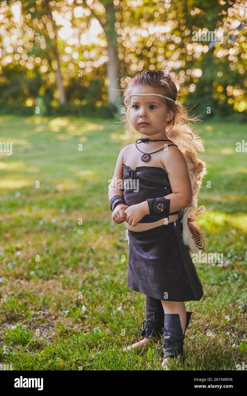 Cute baby dressed in the clothes of primitive people Stock Photo - Alamy