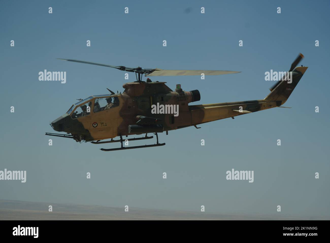 Soldiers from the Jordanian Armed Forces flyover in a Bell AH-1 Cobra ...