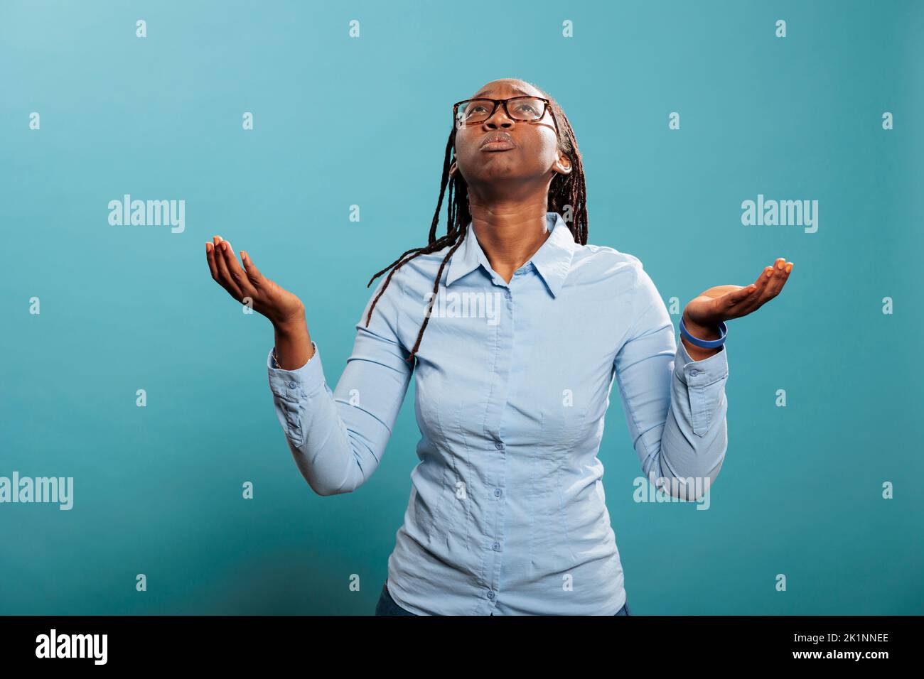 Faithful african american woman with palms faced to sky pleading and ...