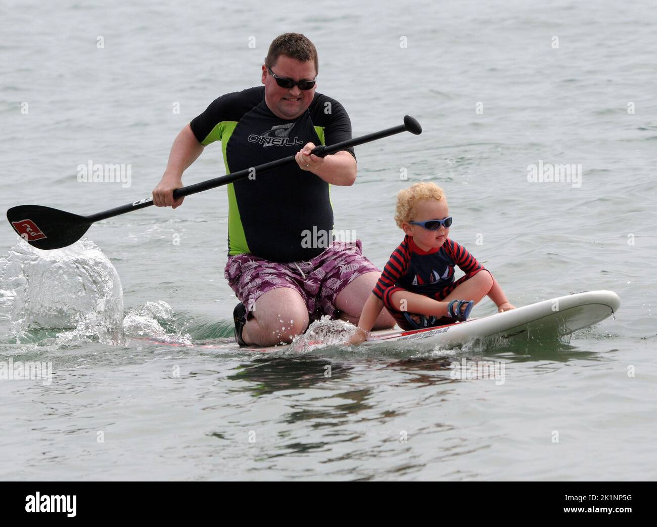 Faster, Faster. A youngster takes a ride on a paddleboard at the ...