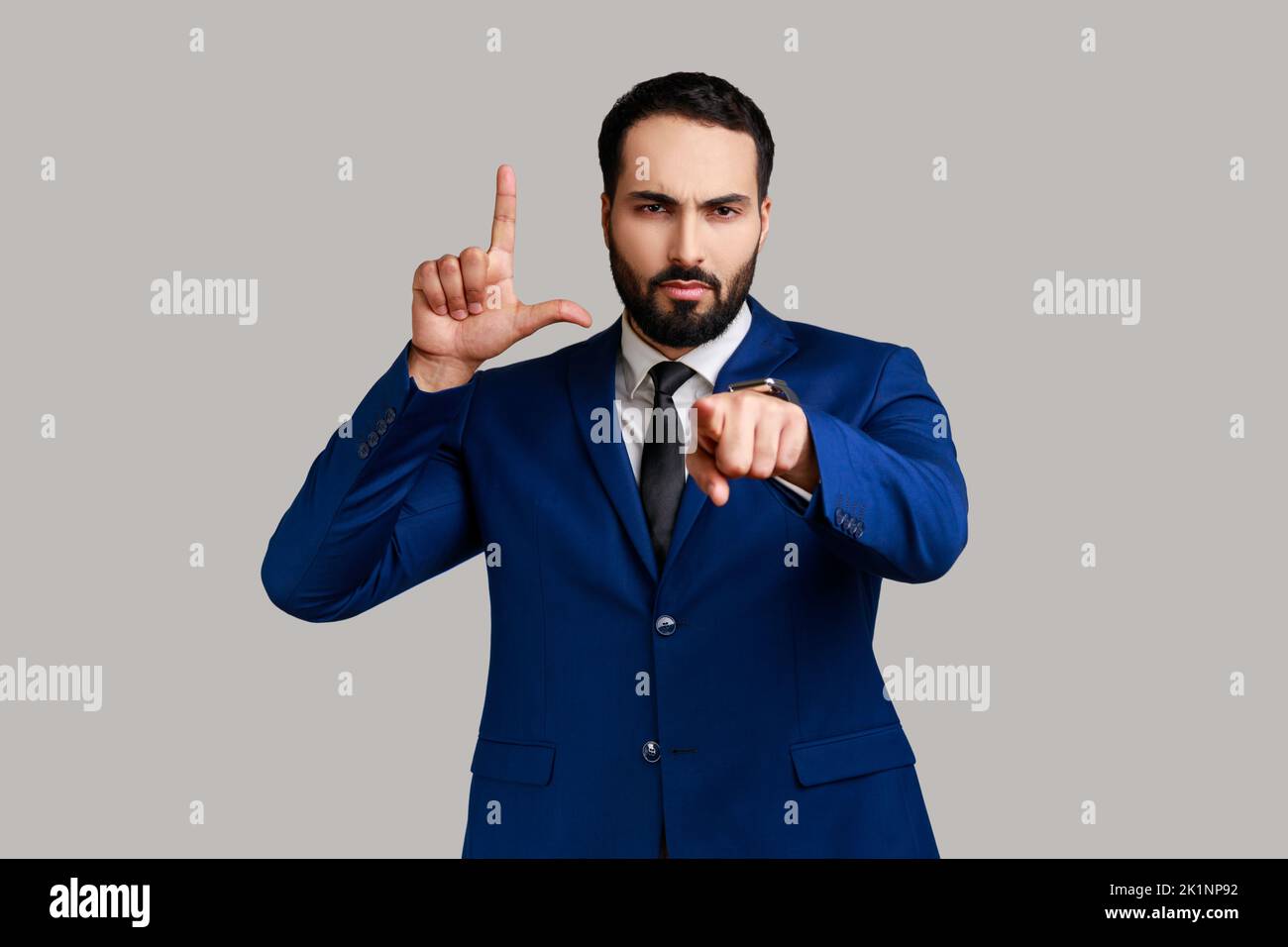 Portrait of strict bearded man pointing at camera and showing lame or ...