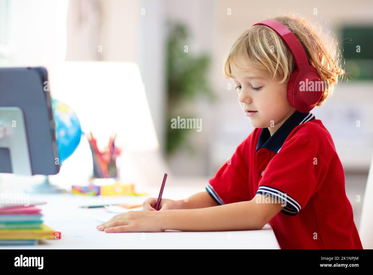 Online remote learning. School kids with computer having video ...