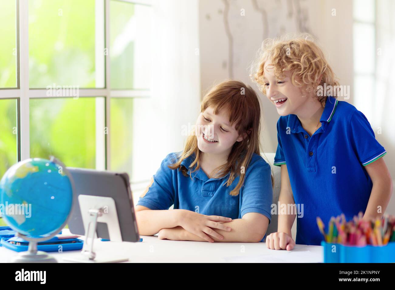 Online remote learning. School kids with computer having video ...