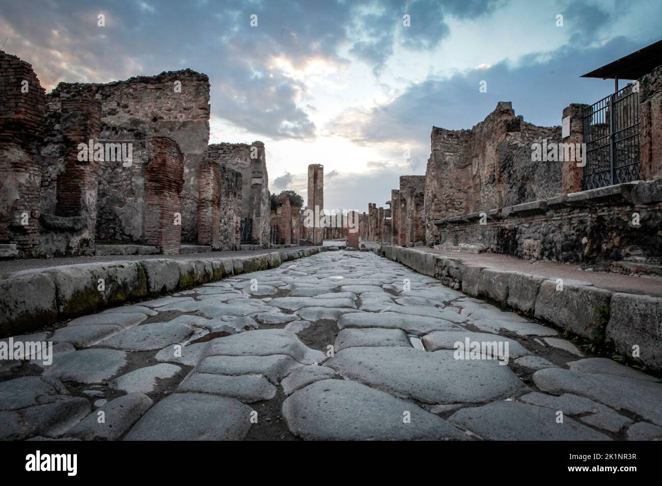 A roman road through the archaeological park / town of Pompeii, a ...