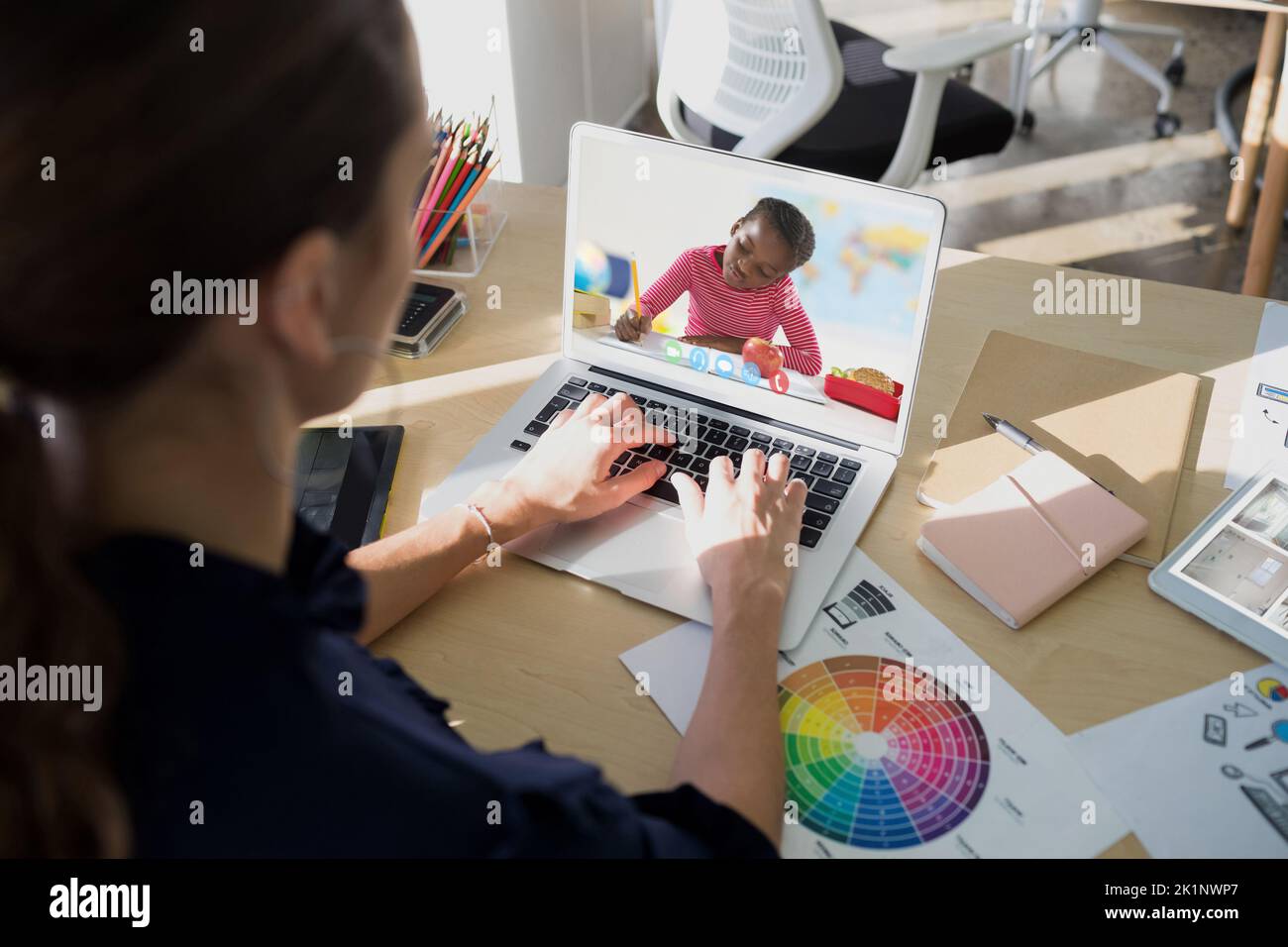 Female teacher having a videocall with female student on laptop at home ...