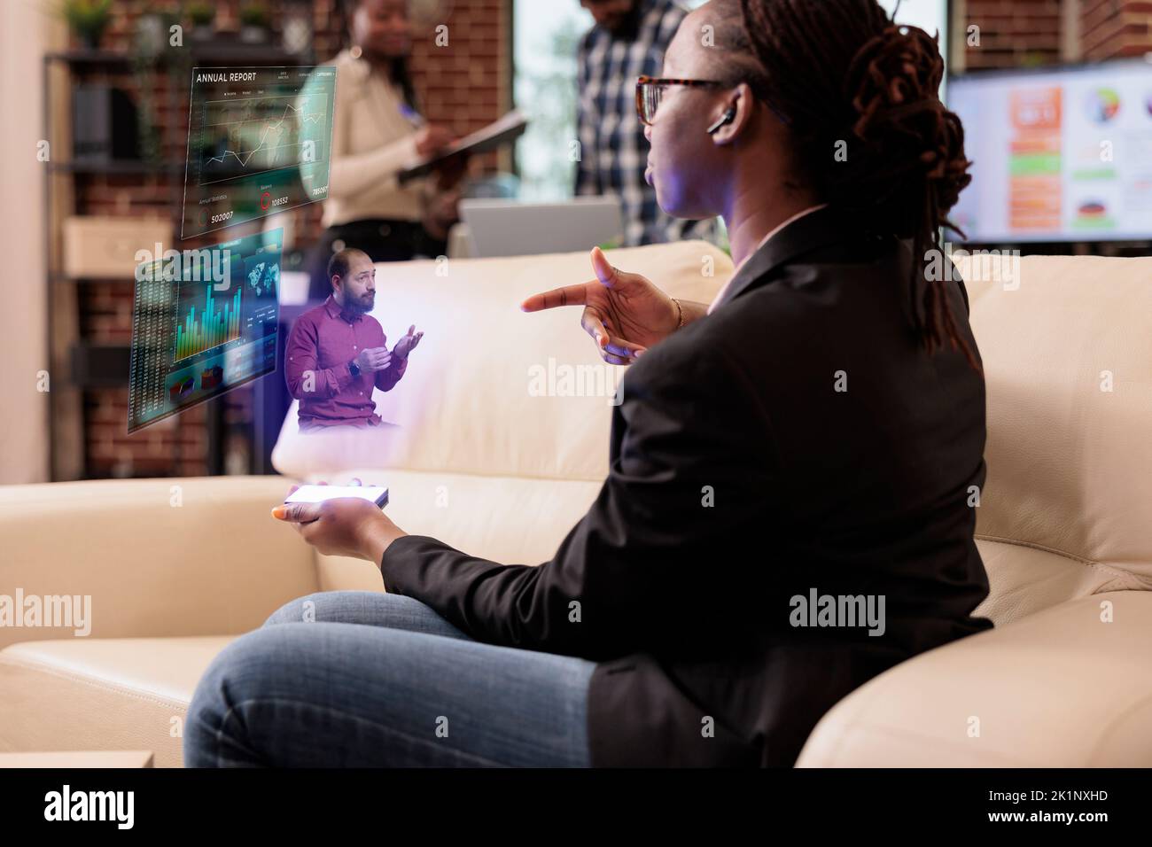 Businesswoman using augmented reality hologram in company office ...
