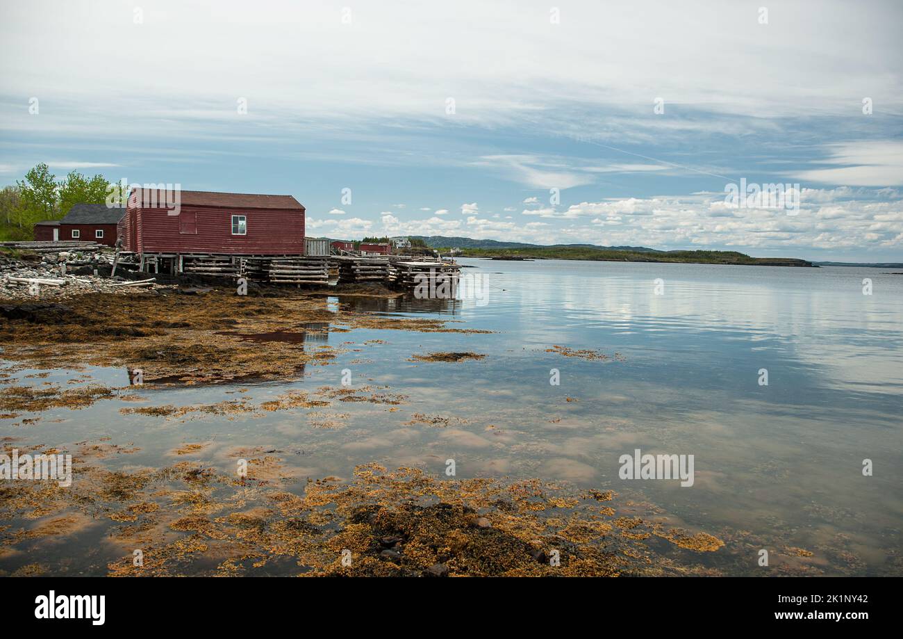 Fishing stage on calm water in a quiet bay Stock Photo - Alamy