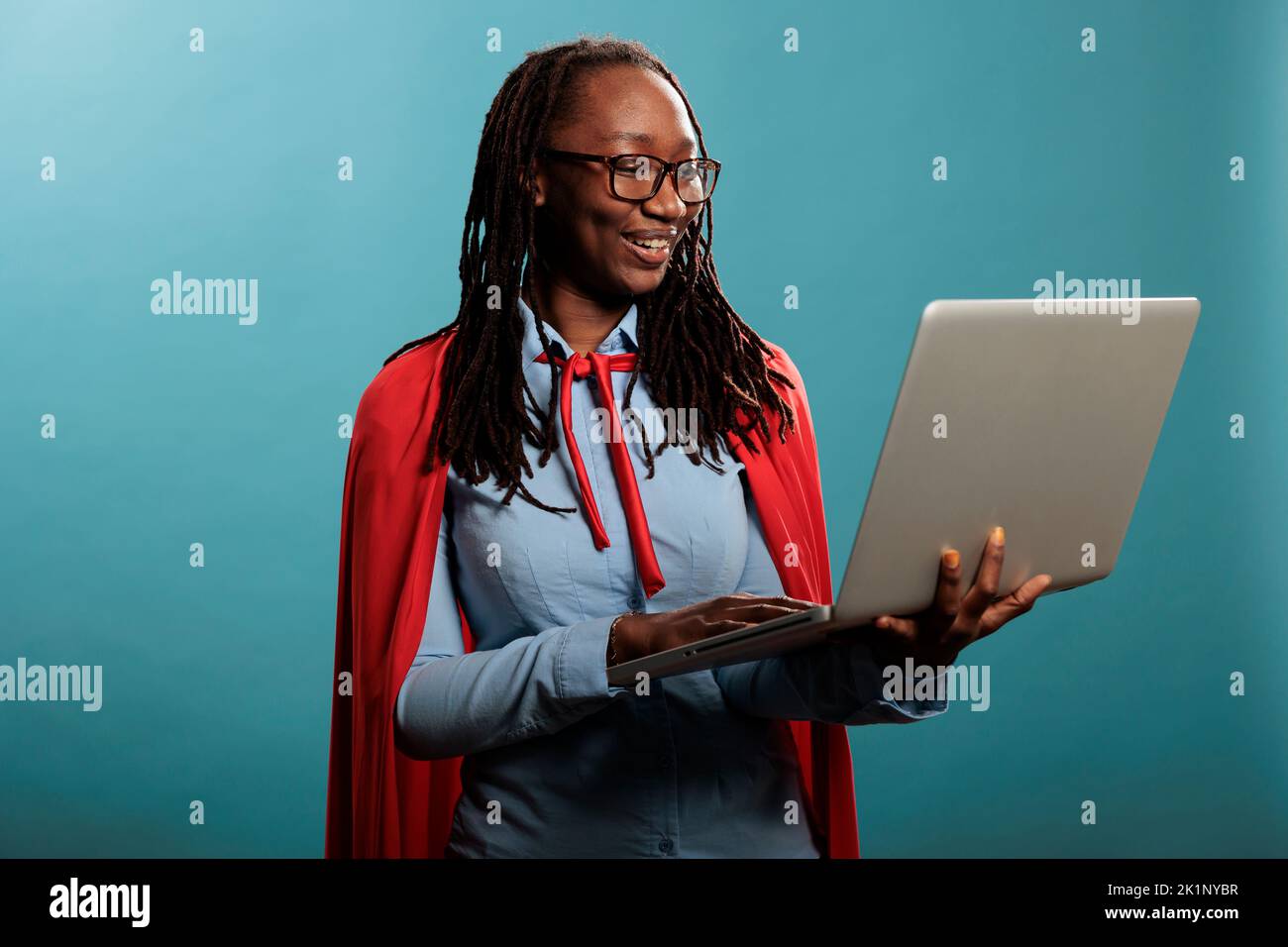 Confident and joyful justice defender wearing mighty hero cape while ...