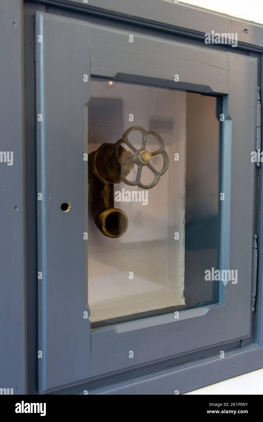 Water pipe with stopcock in a box in the wall Stock Photo - Alamy