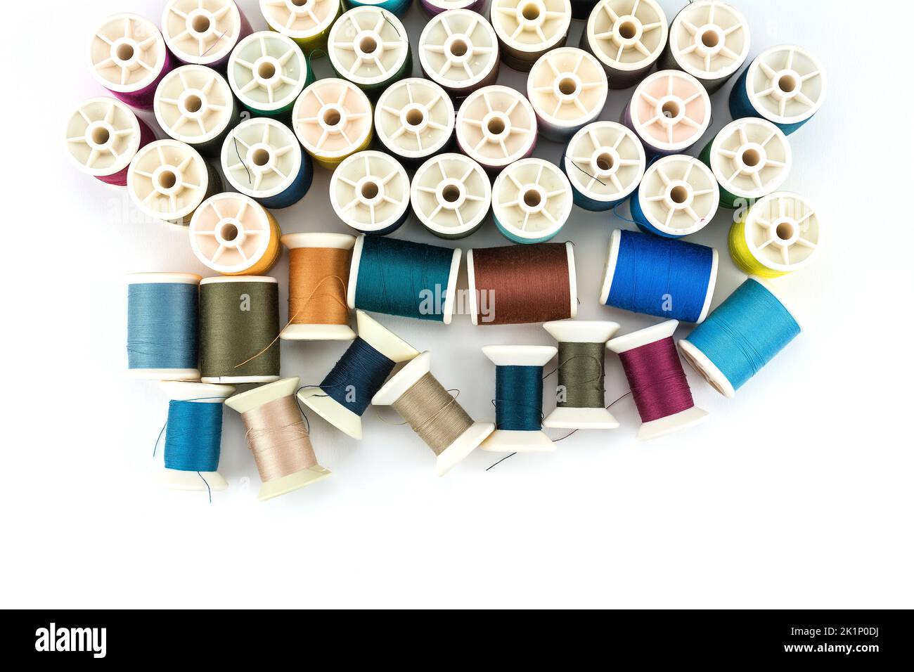 Thread tubes for sewing thread have many colors and are placed on a ...
