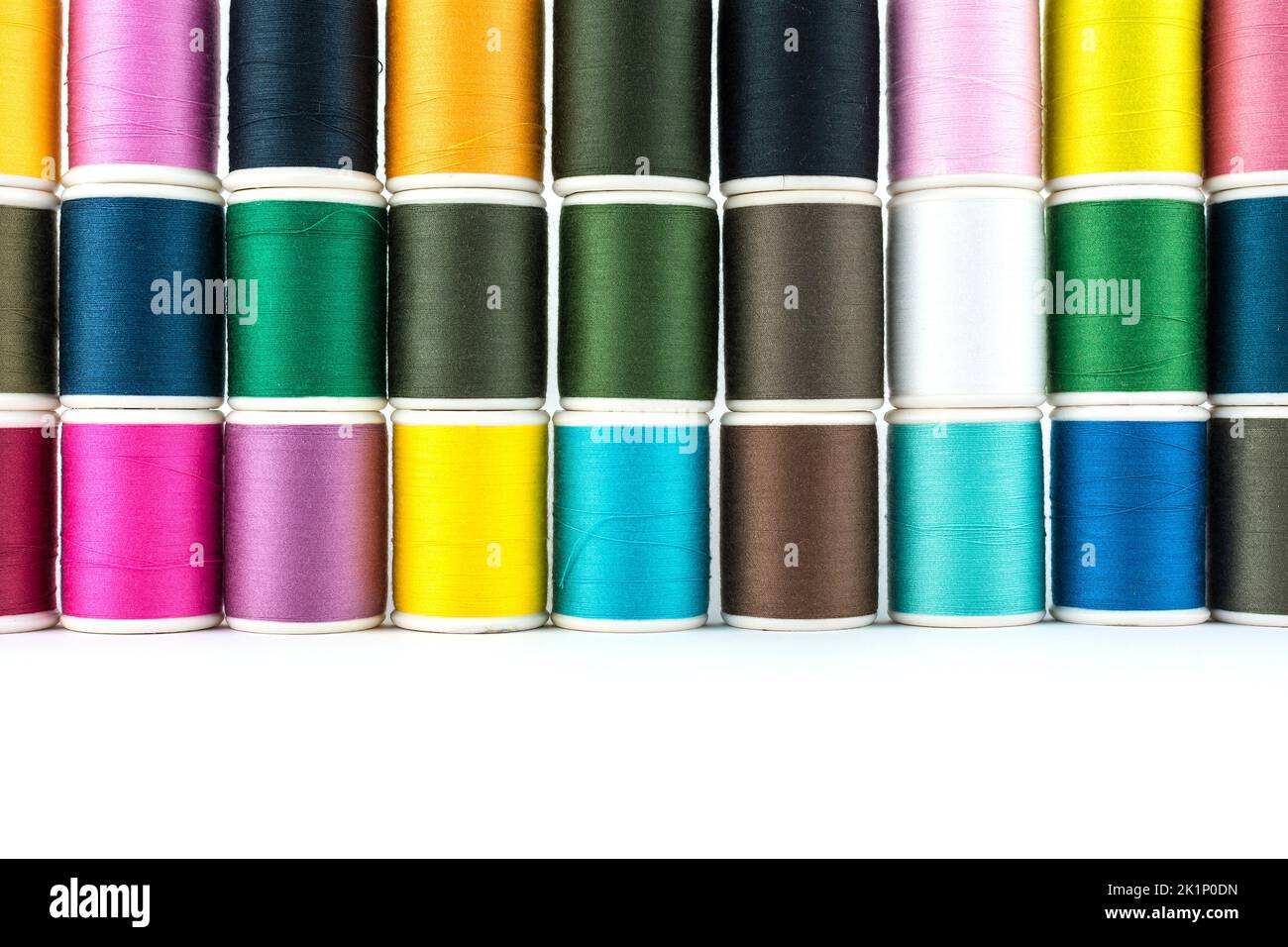 Thread tubes for sewing thread have many colors and are placed on a ...