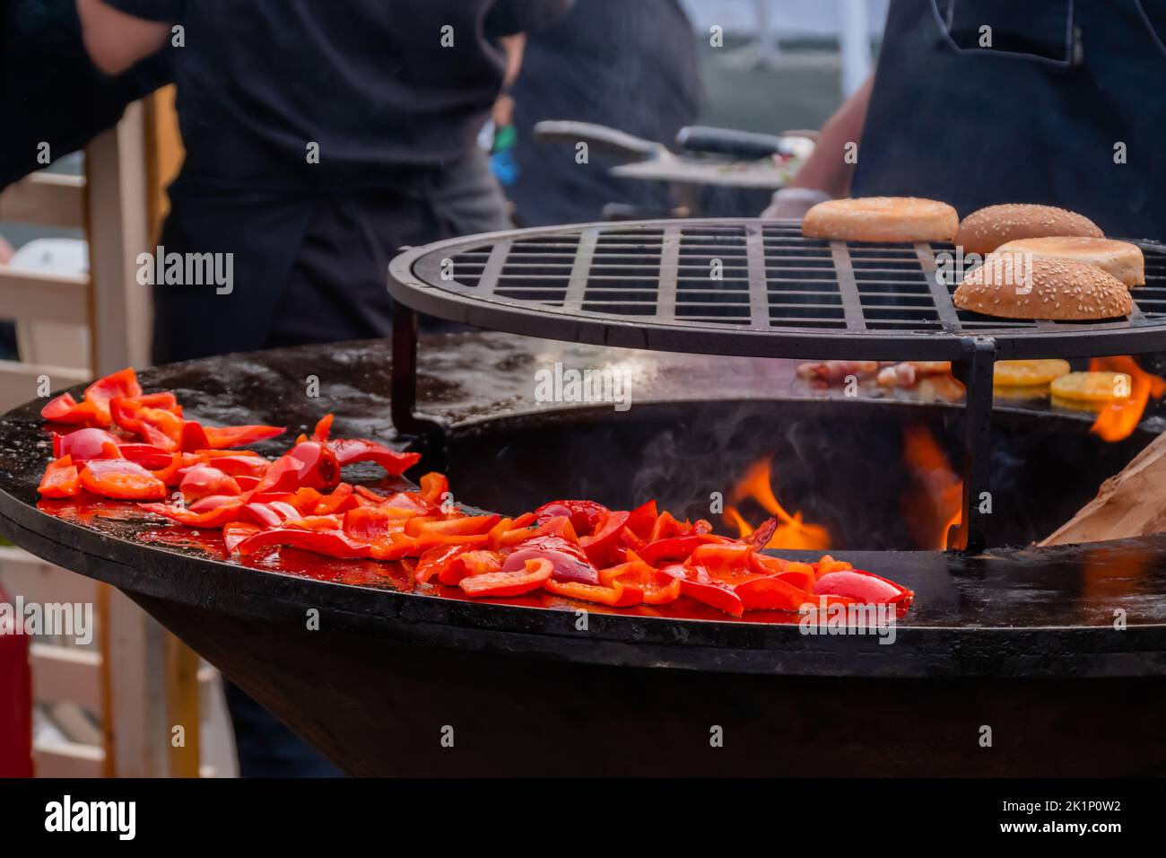Process of grilling sliced red sweet bell pepper on brazier - close up ...