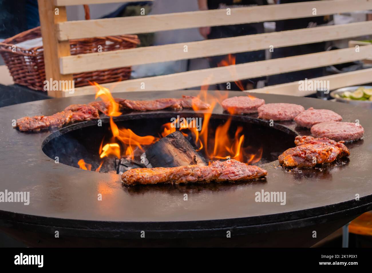 Process of grilling meat steaks on brazier with hot flame: close up ...