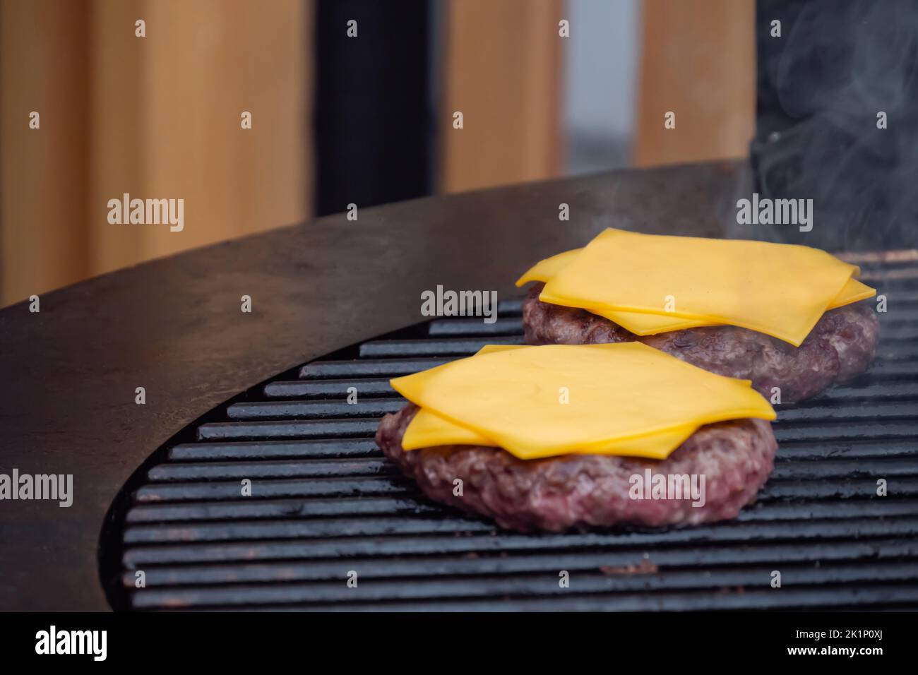Process of grilling cutlets for burgers on brazier: close up Stock ...