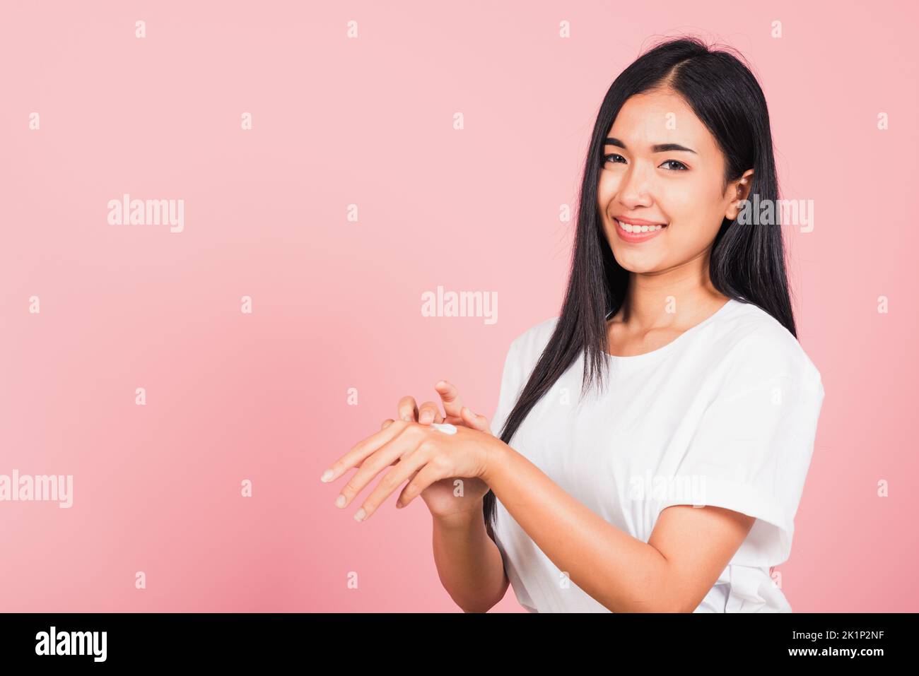 Portrait of Asian beautiful young woman applying lotion cosmetic ...