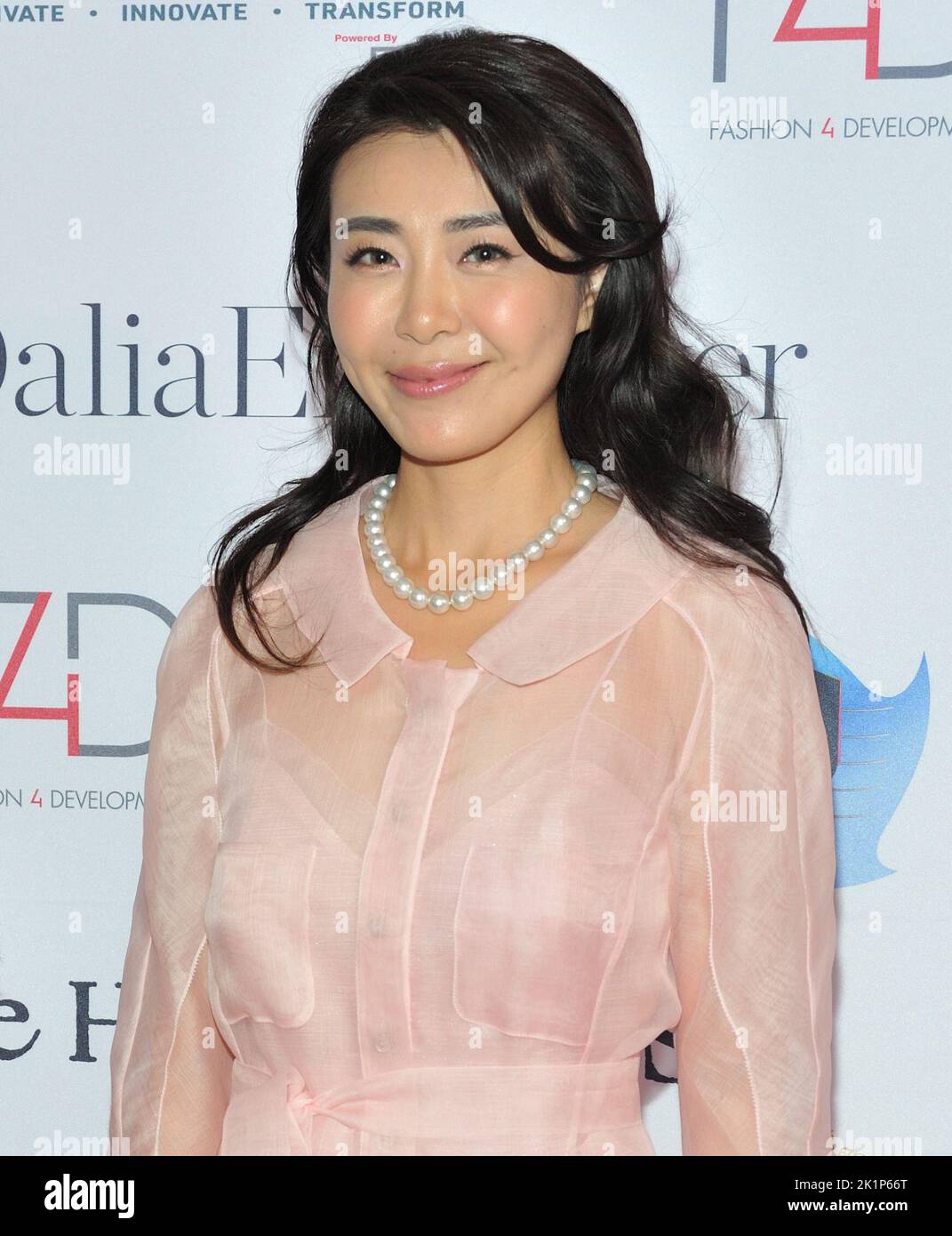 Cola Xia (R) and son attend the Fashion4Development 2nd Annual ...