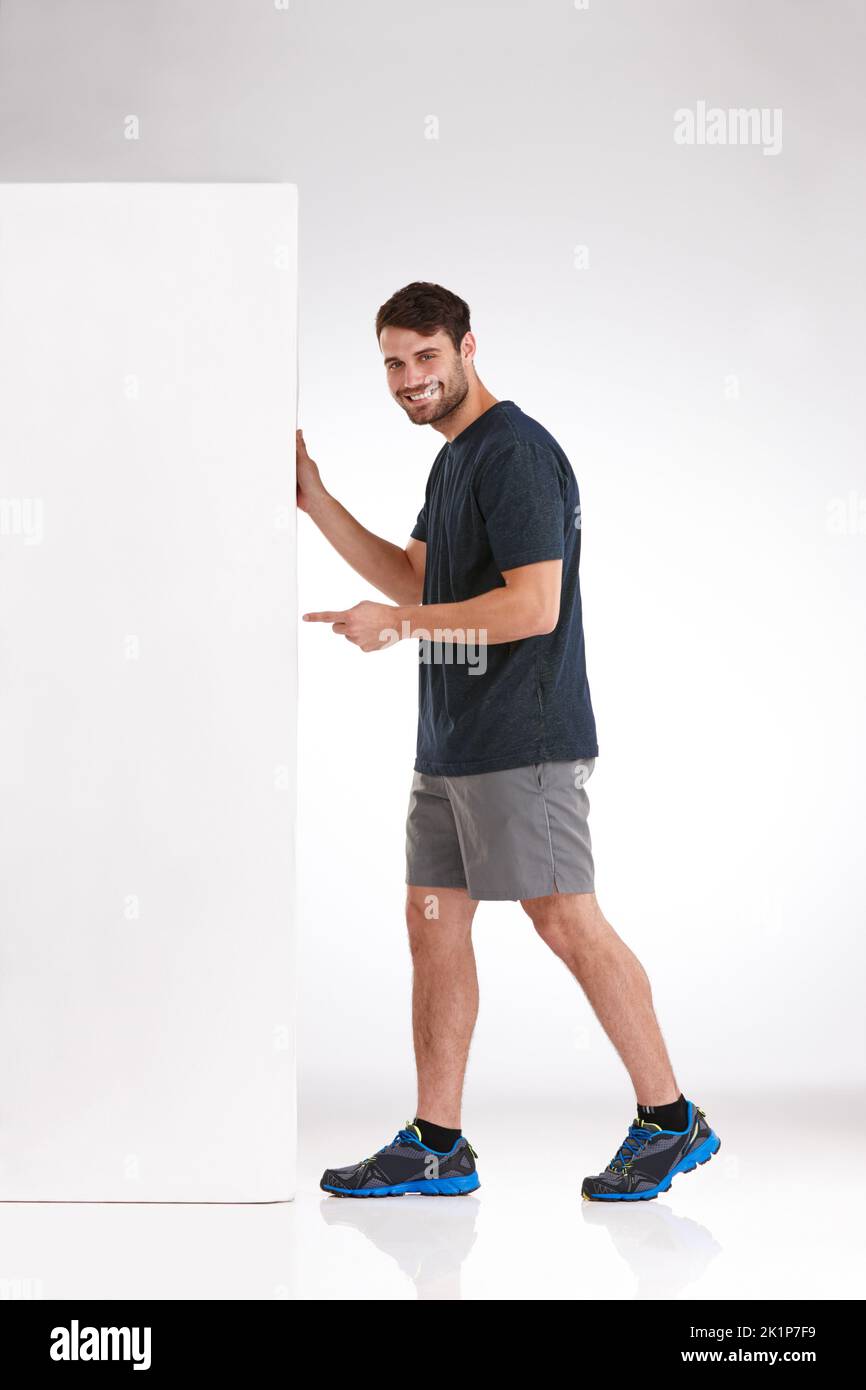 This is the way to go. Studio shot of a smiling young man pointing to a ...