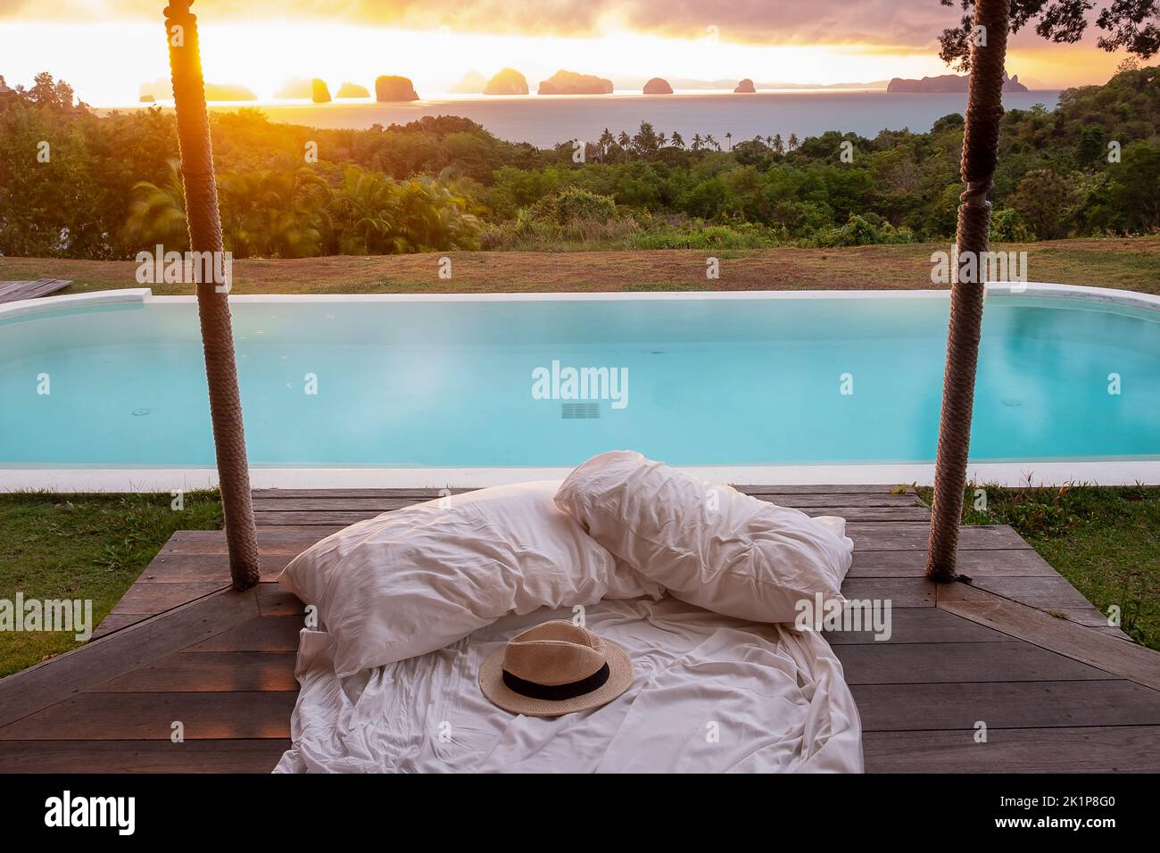 Traveler hat on white bed against Beautiful ocean view background ...