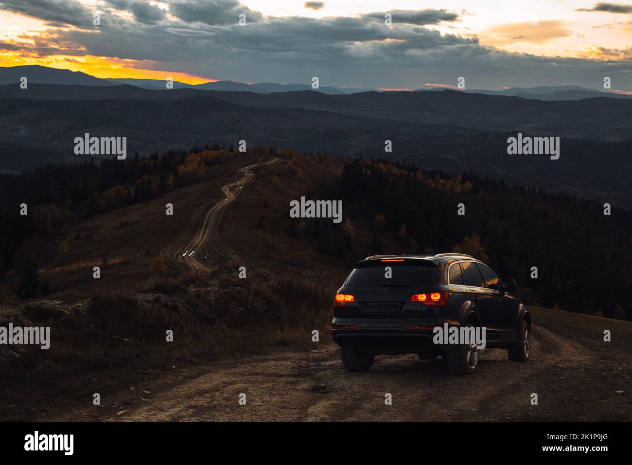 Car is going down offroad in mountains during autumn evening Stock ...