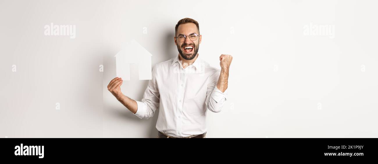 Real estate. Satisfied man rejoicing of founding perfect home apartment ...