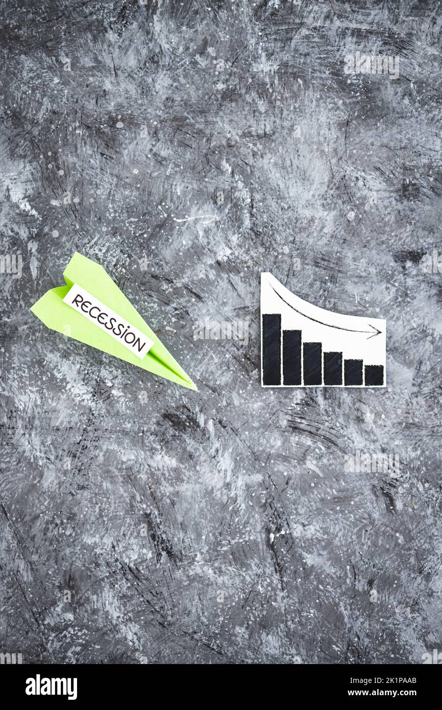 recession text on paper plane going down with stats graphs, concept of ...