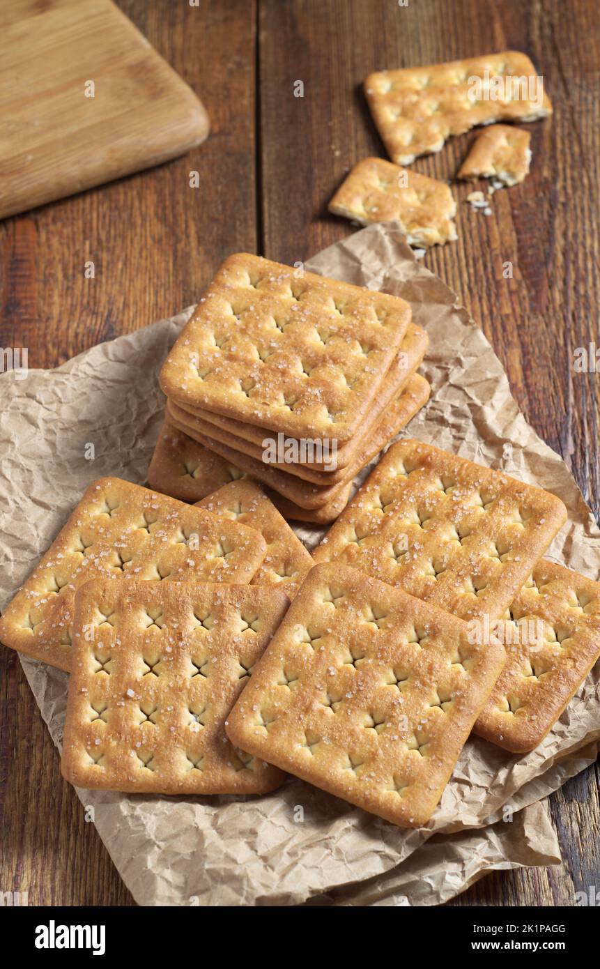 High angle view of square crackers on crumpled paper on the table Stock ...