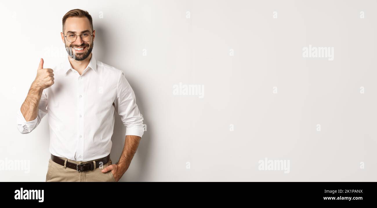 Satisfied successful boss showing thumb up, approve and praise good ...