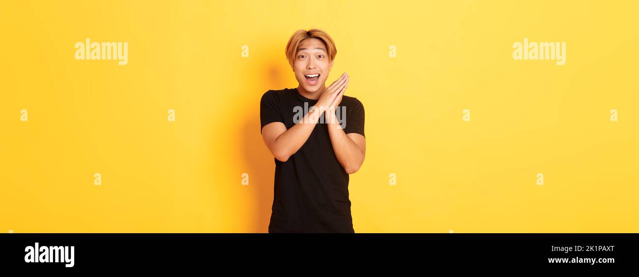 Portrait of happy and surprised asian man clap hands and smiling ...