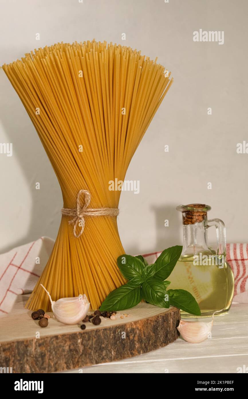 On the table is a pack of spaghetti tied with string. On a light ...