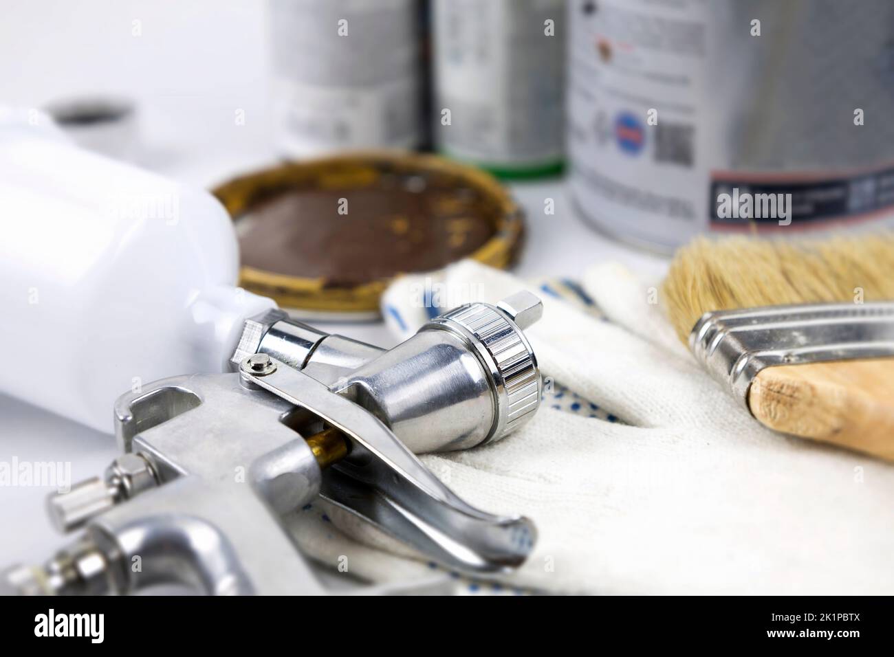 Instructions and a paint spray gun at work at the workplace in the ...