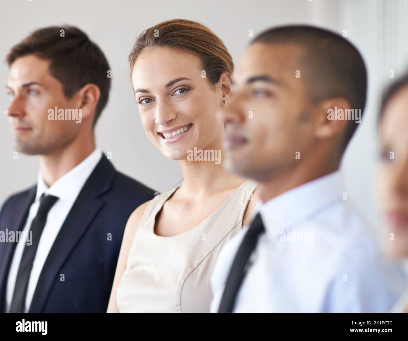 She is the picture of success. Portrait of a small group of colleagues ...