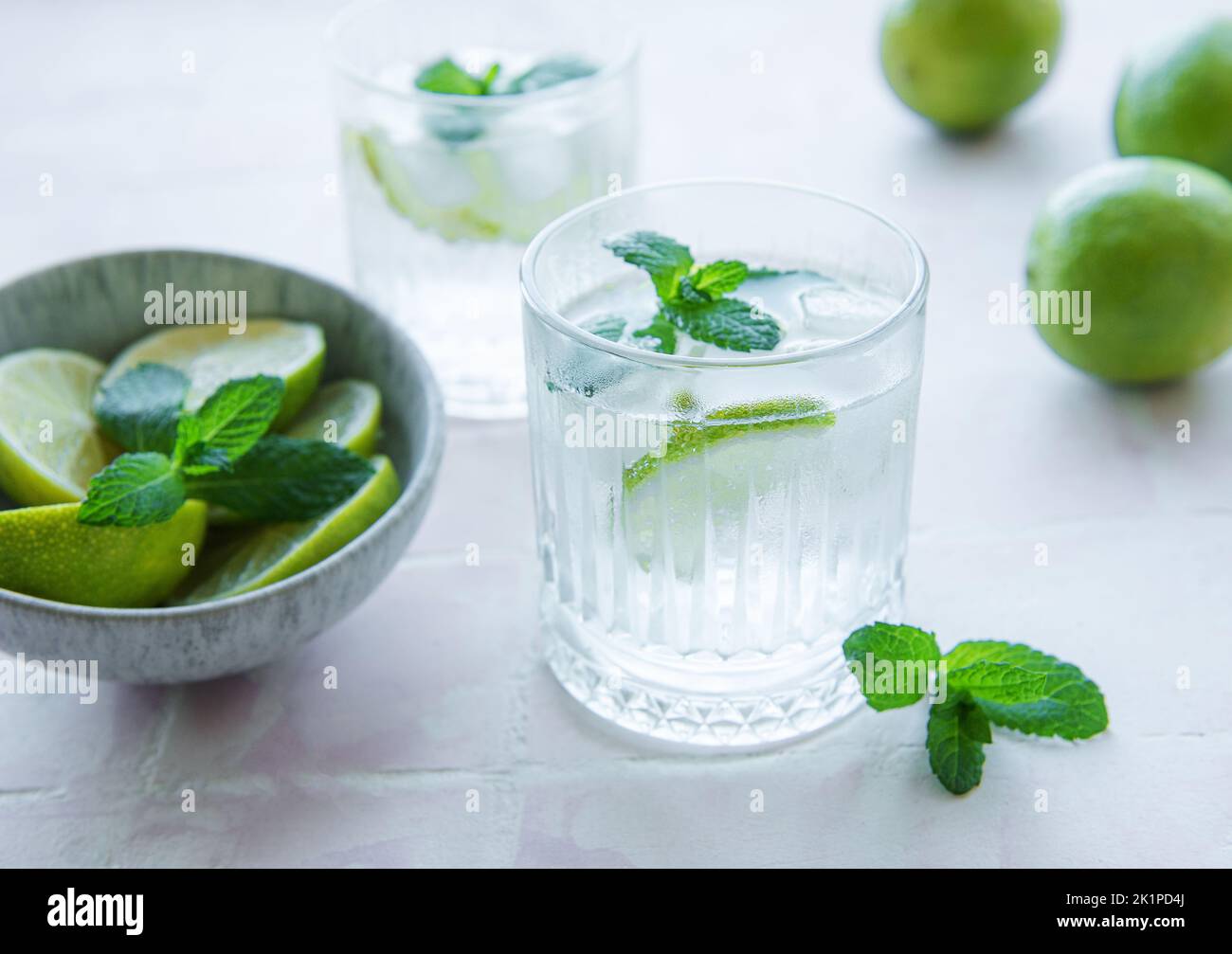 Iced cold lemonade with fresh lime and juice. Summer drink in glass ...