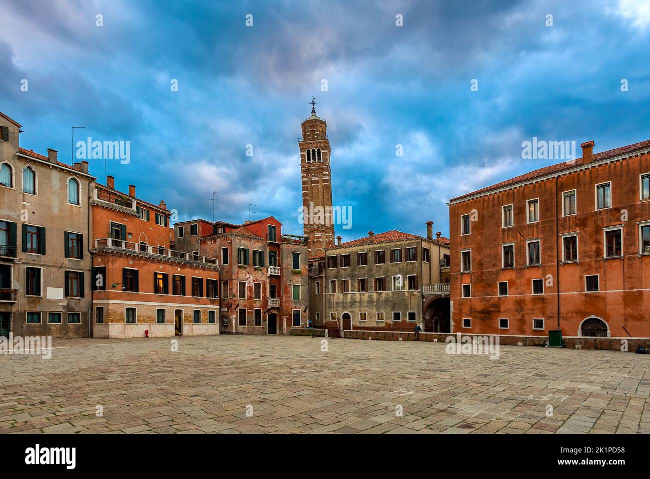 Small town square surrounded by typical old houses as leaning belfry on background in Venice ...