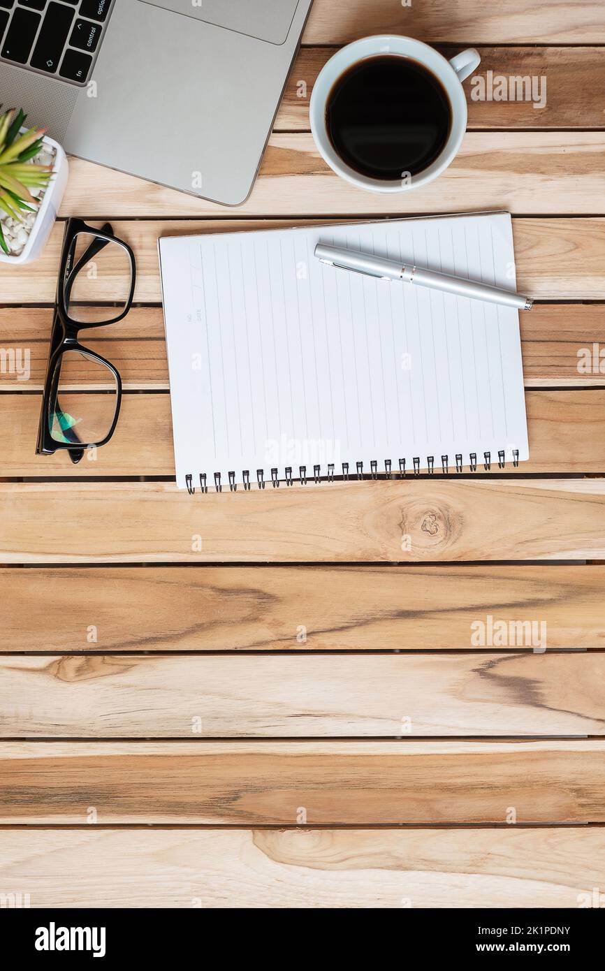Top view Office desk with pen, computer laptop, blank notebook, plant ...